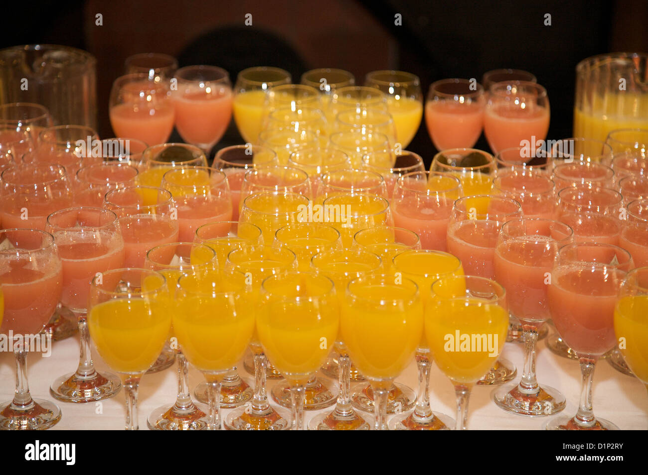 Orange & guava juice in glasses in a patterned display Stock Photo - Alamy