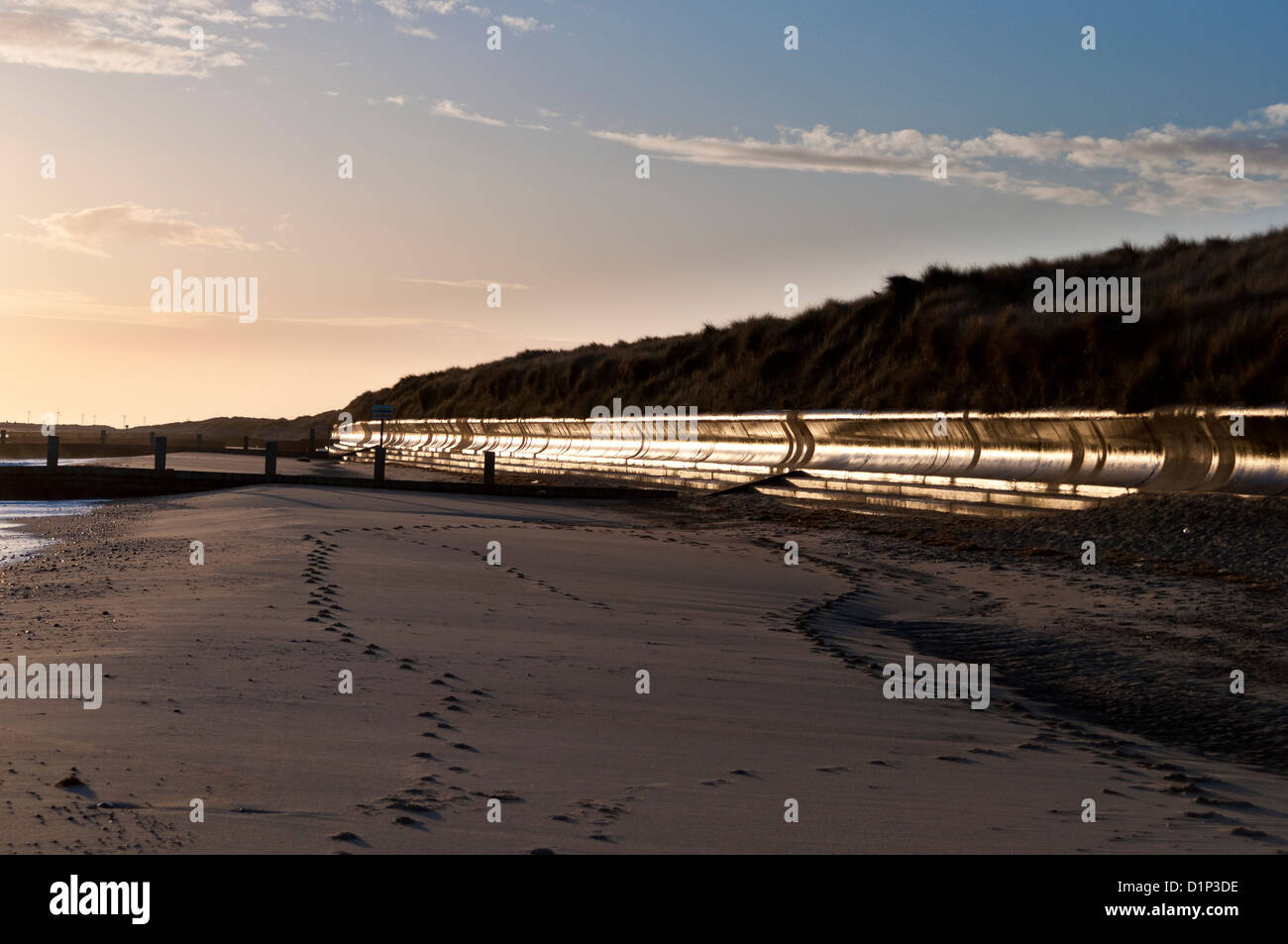 Curved concave concrete sea wall Winterton dunes in morning dawn light ...