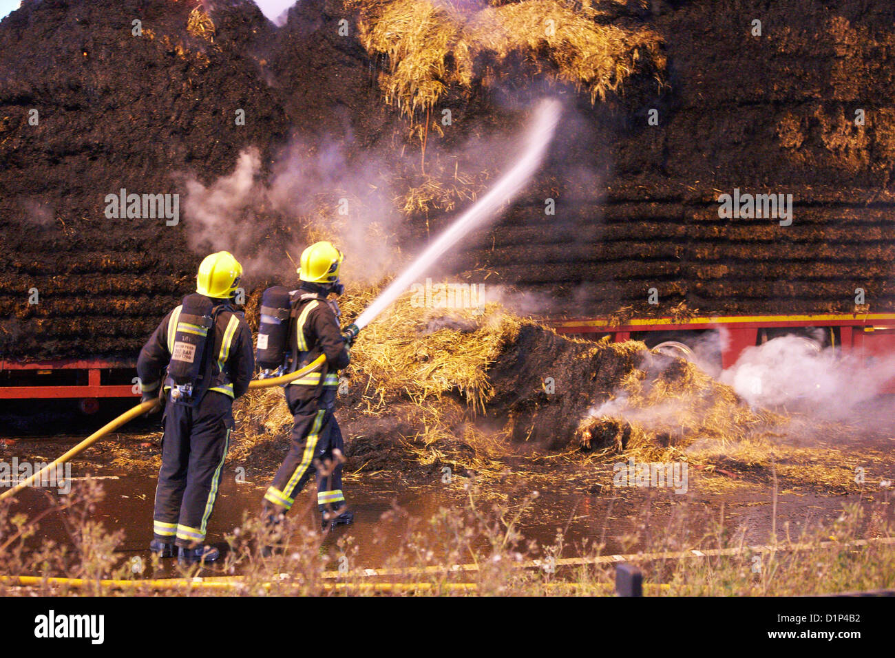Fire fighters deal with a large hay lorry fire on the A41 near Aston ...
