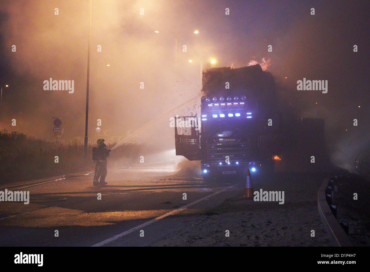 Fire fighters deal with a large hay lorry fire on the A41 near Aston ...