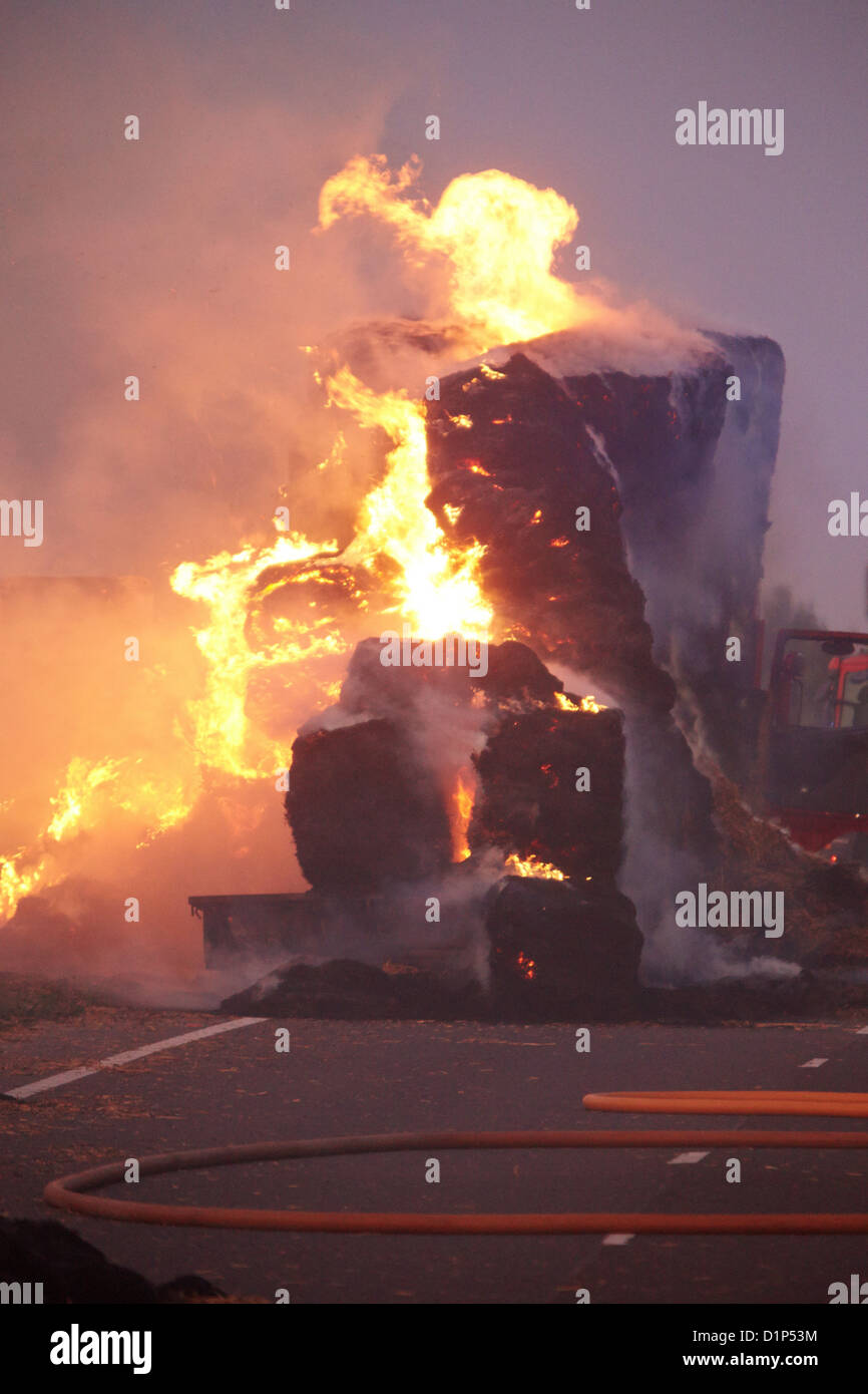 Fire fighters deal with a large hay lorry fire on the A41 near Aston ...