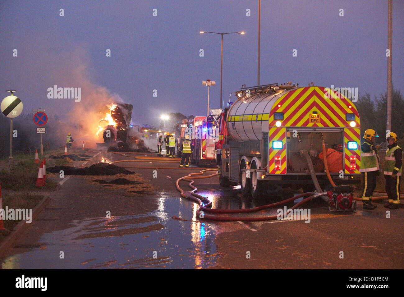Fire fighters deal with a large hay lorry fire on the A41 near Aston ...