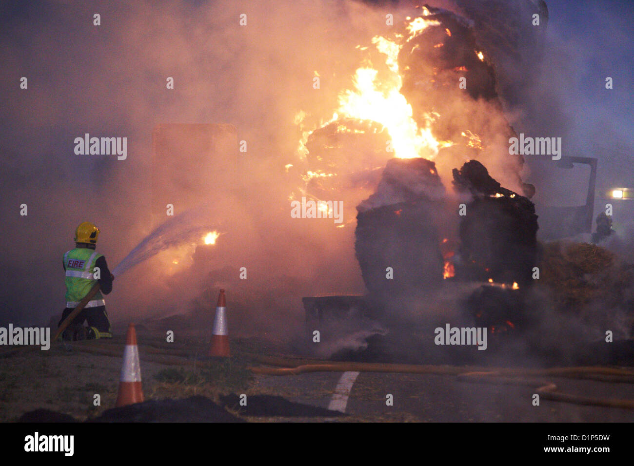 Fire fighters deal with a large hay lorry fire on the A41 near Aston ...