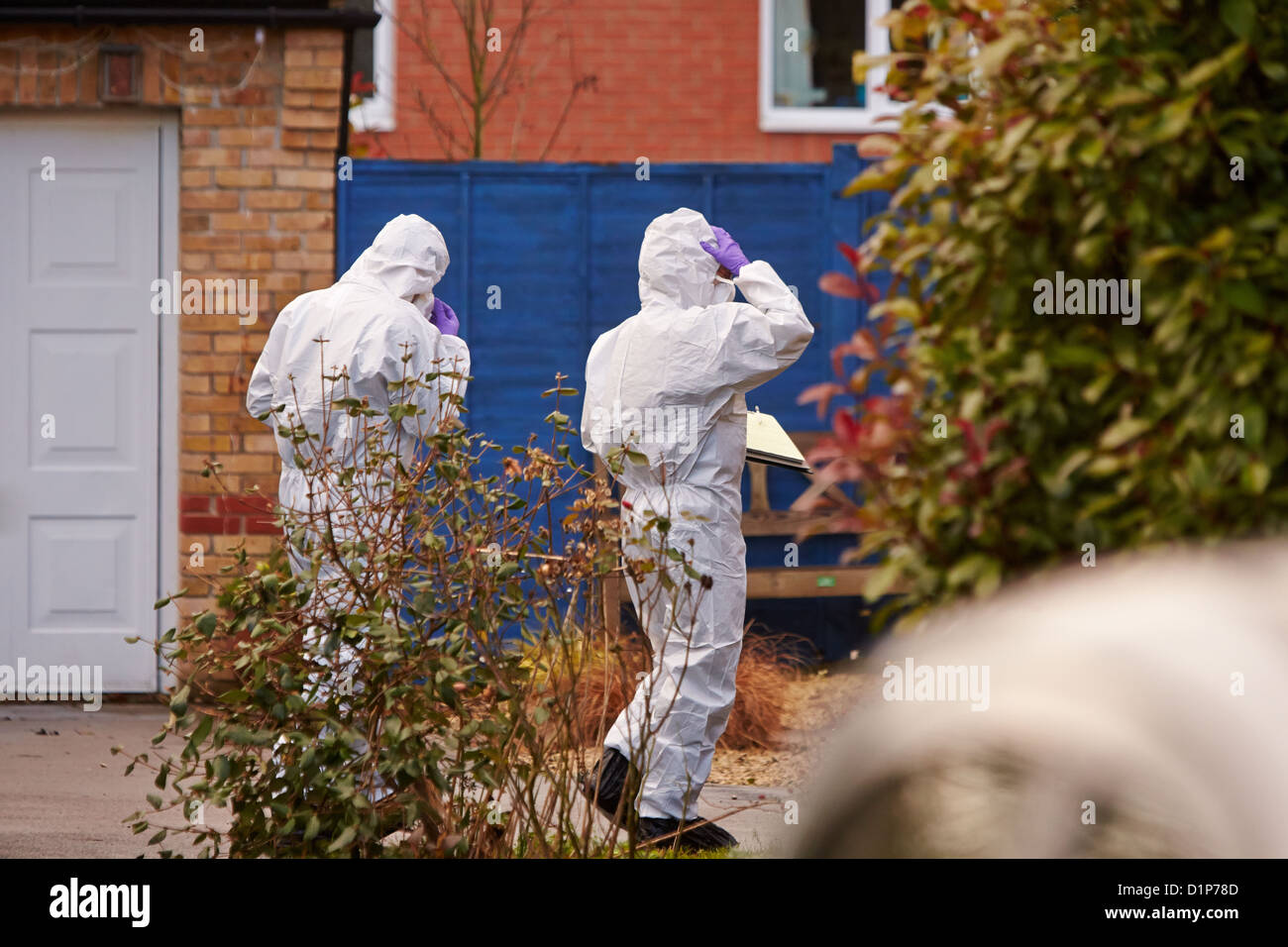 Forensic officers investigate the scene of the murder of Janee Parson ...
