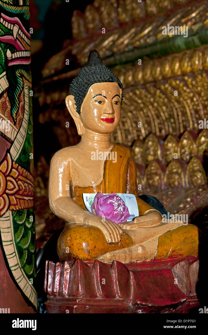 Marble Buddha statue carrying a banknote offering and a lotus flower ...