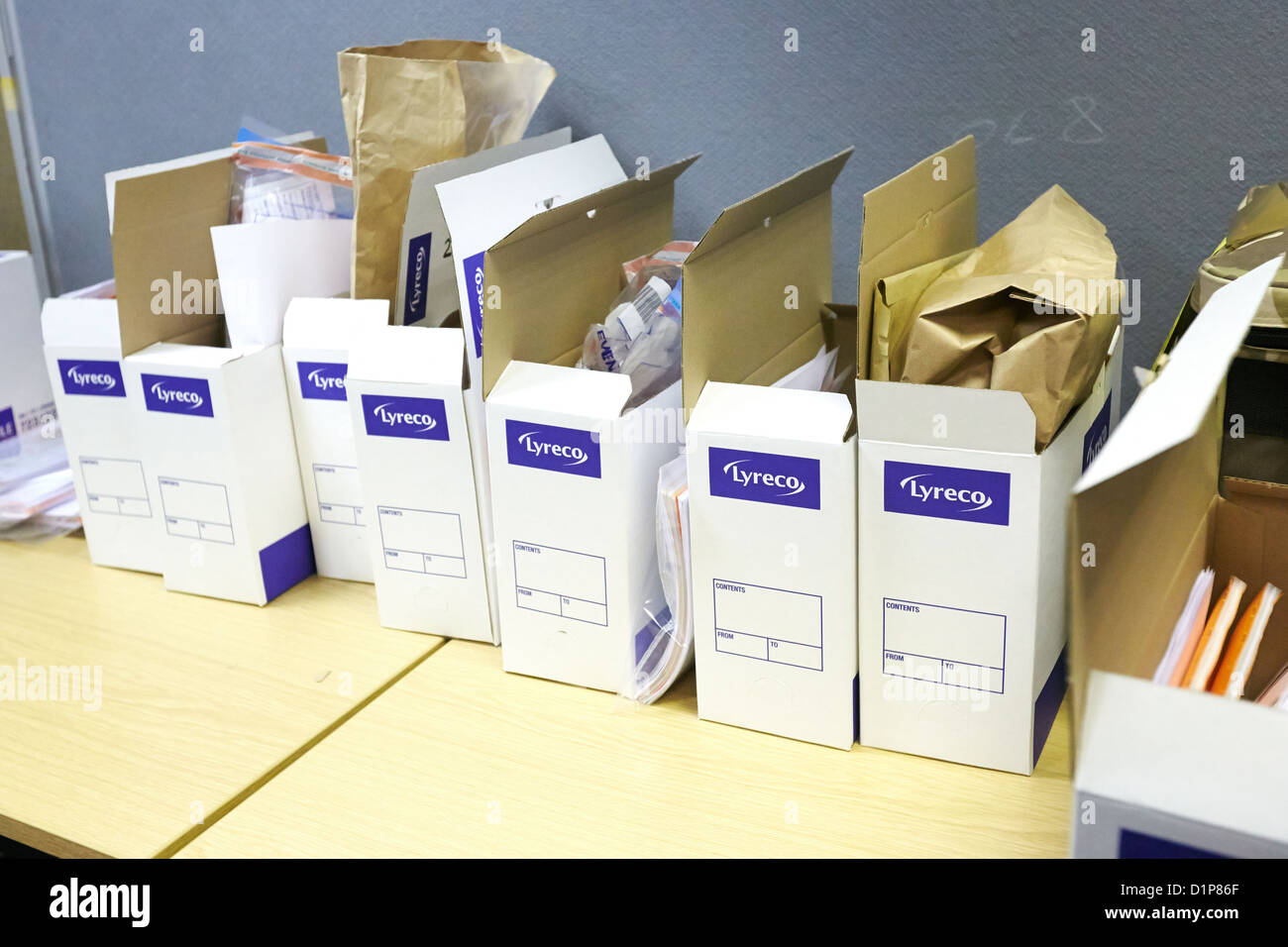 Evidence bags containing cash and drugs seized as part of drugs raids ...