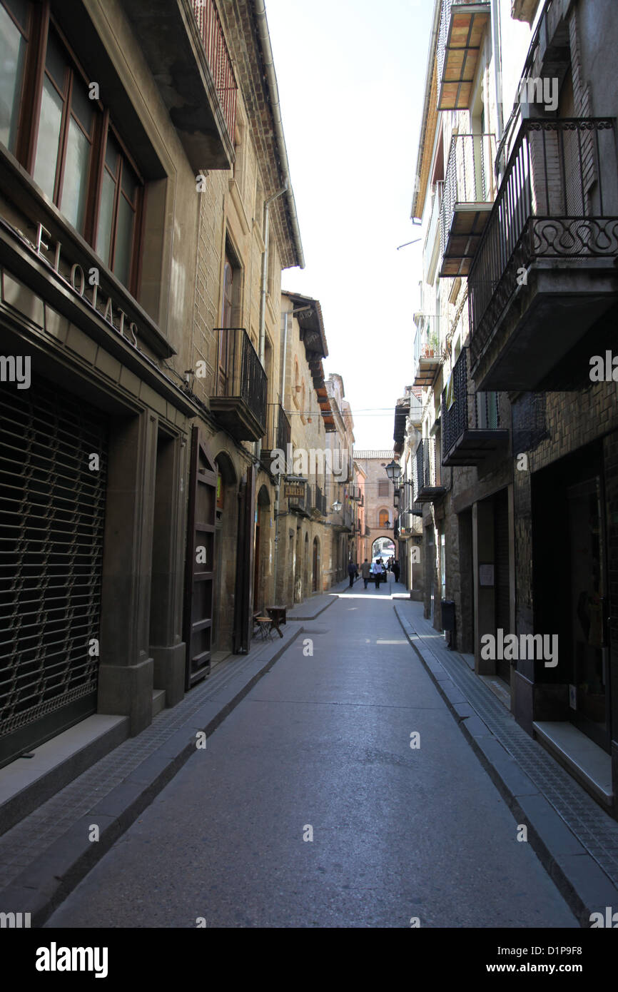 Narrow Spanish high street in shadow Stock Photo - Alamy