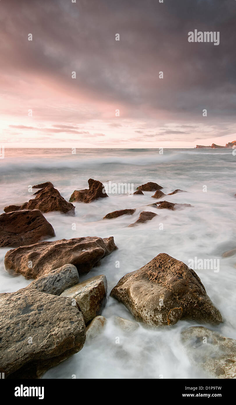 Atlantic seascape with silky water and stones Stock Photo - Alamy