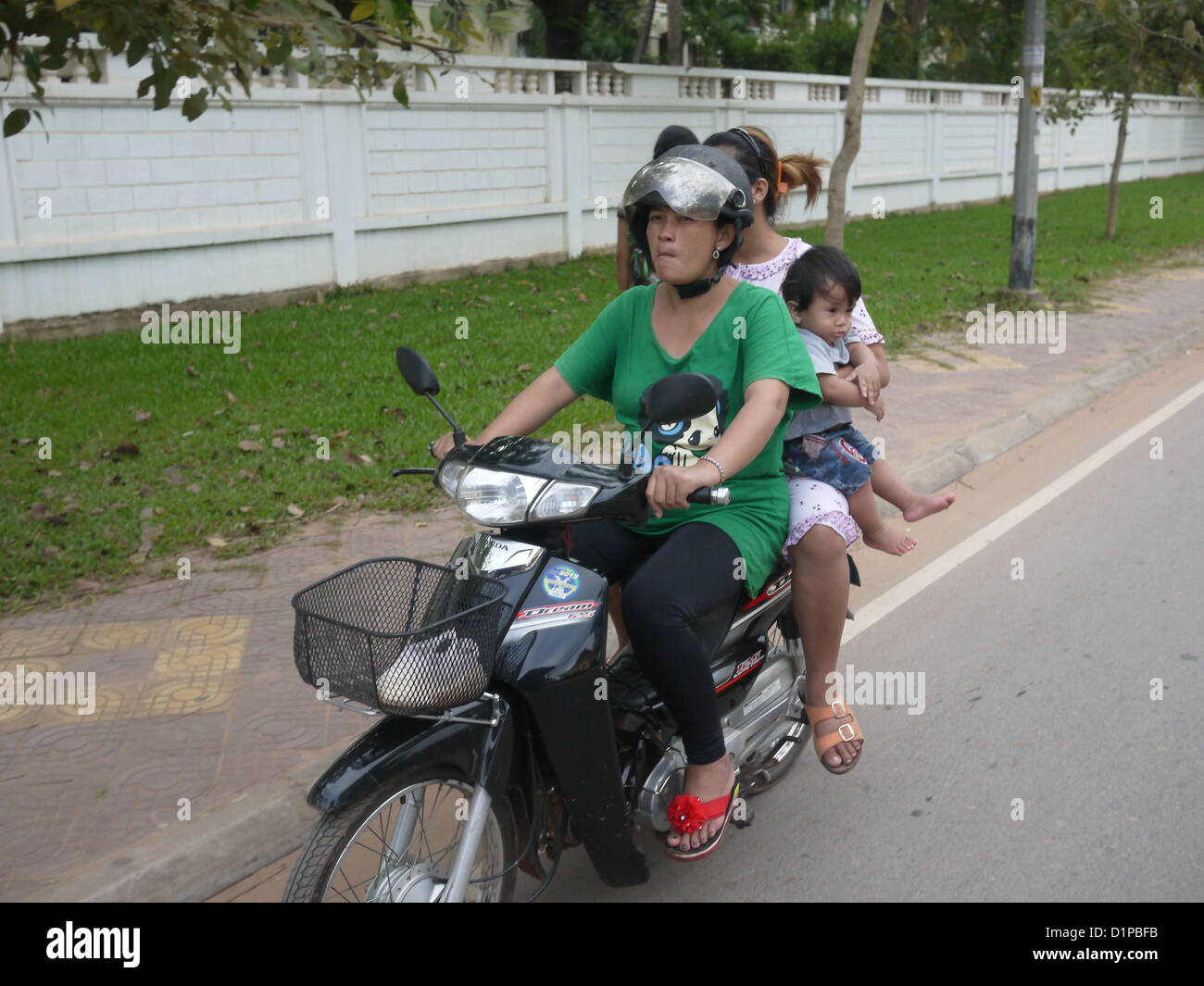 overloaded scooter Asian family male female Stock Photo - Alamy
