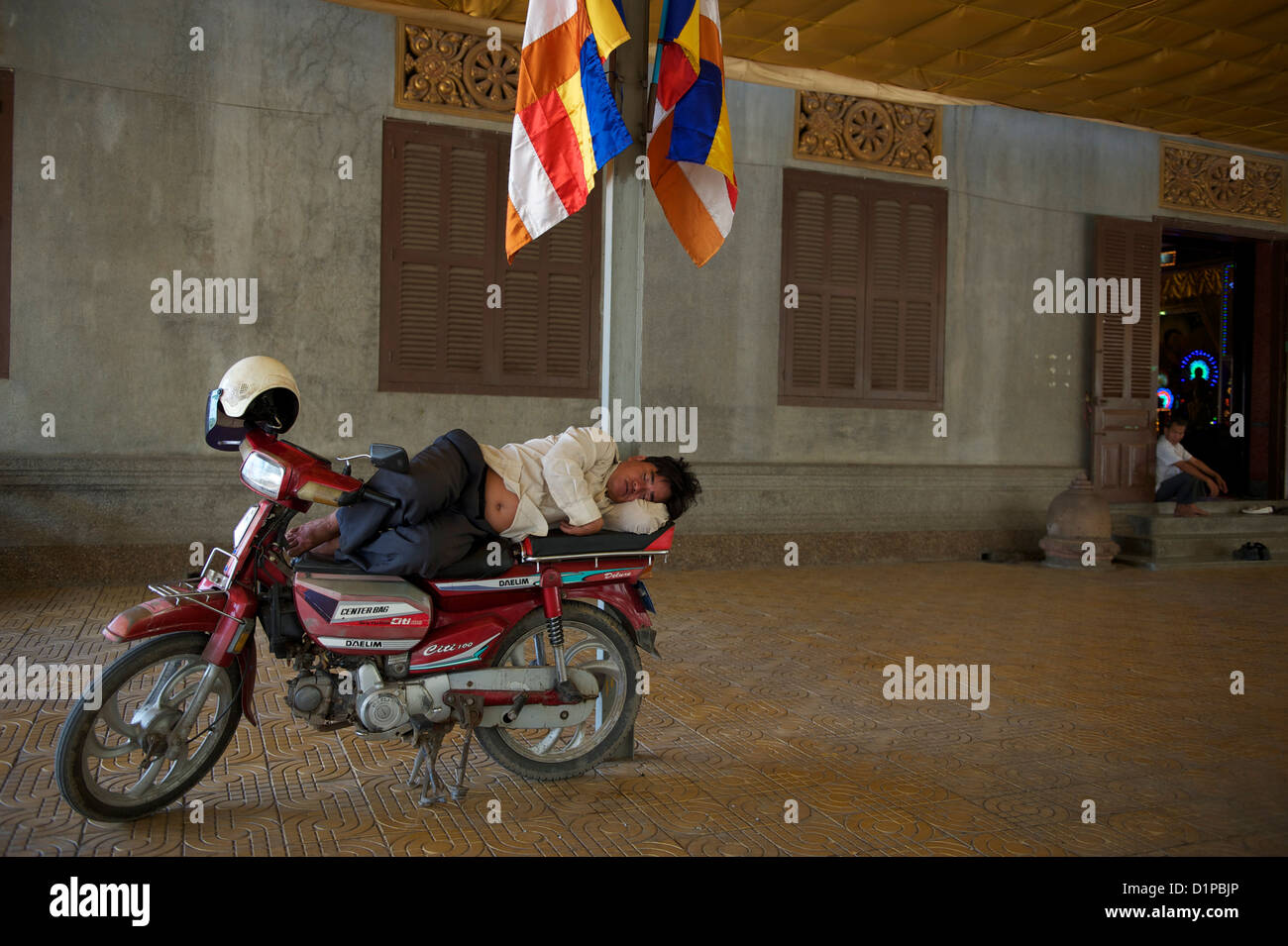 sleeping on top of a motorbike,afternoon nap Stock Photo - Alamy