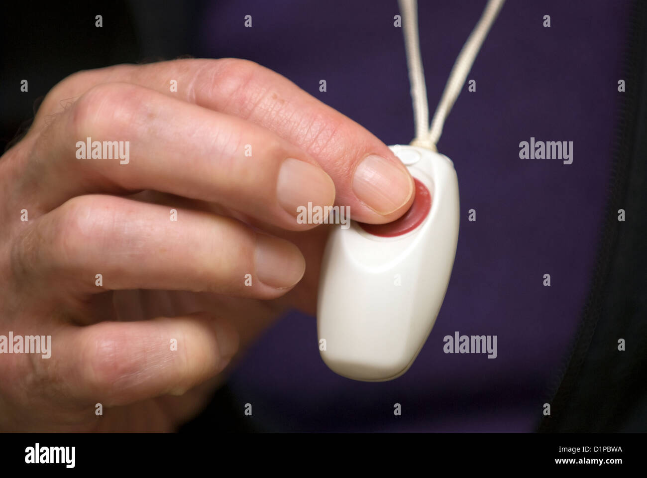 Man with physical disability wearing a pendant emergency trigger which ...