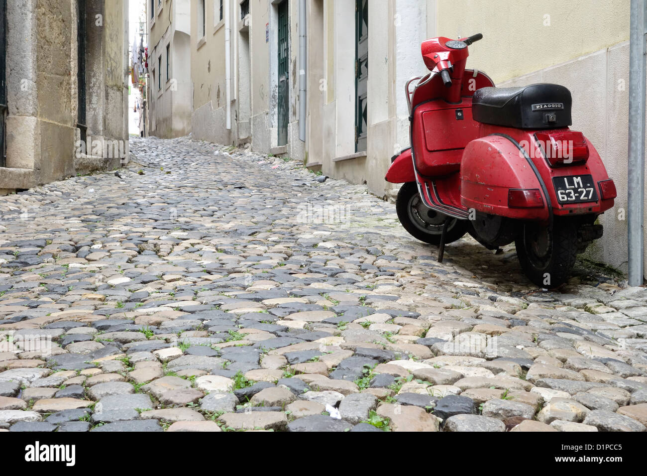 lisbon portugal scooter vespa cobblestone cobbles street color red ...