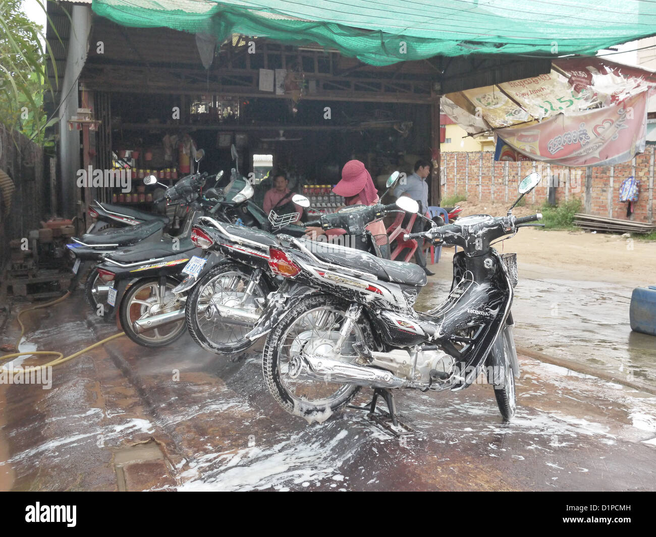 cleaning washing scooters motorbikes Stock Photo - Alamy