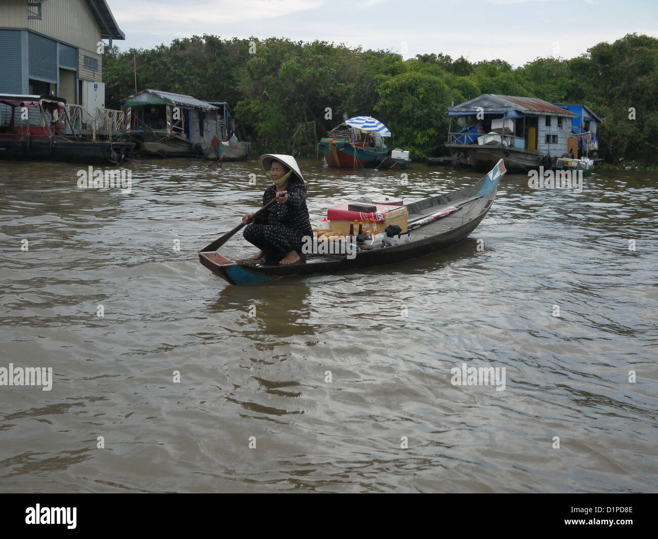 woman steering small wooden boat lake selling good Stock Photo - Alamy