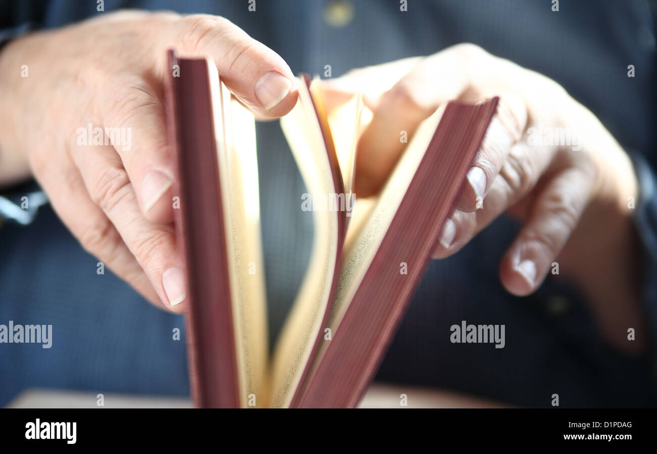 Hands paging through book hi-res stock photography and images - Alamy