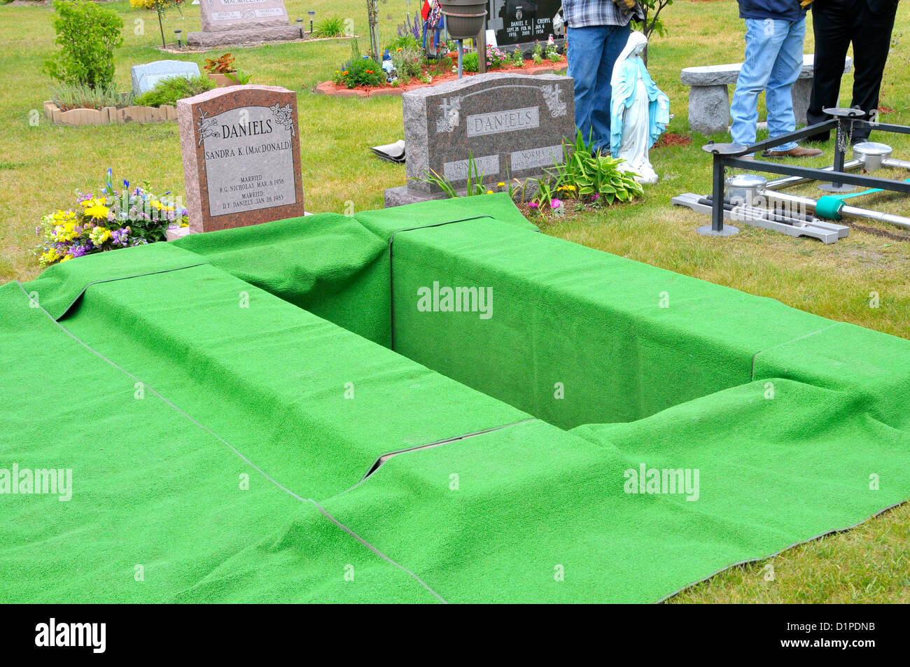 Funeral ending at cemetery gravesite with mourners and pallbearers ...