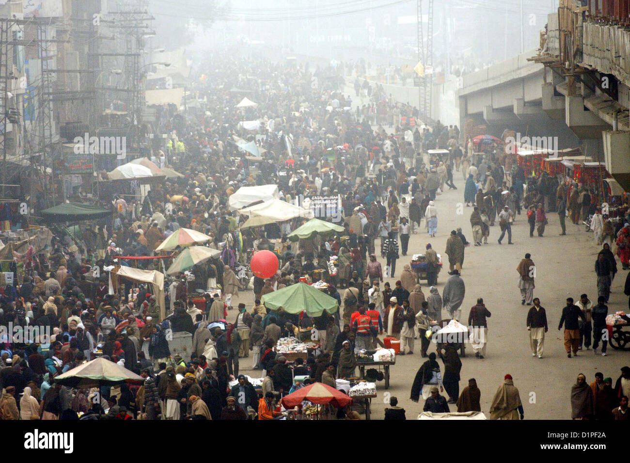 A large number of people gather outside at the shrine of Data Ganj ...