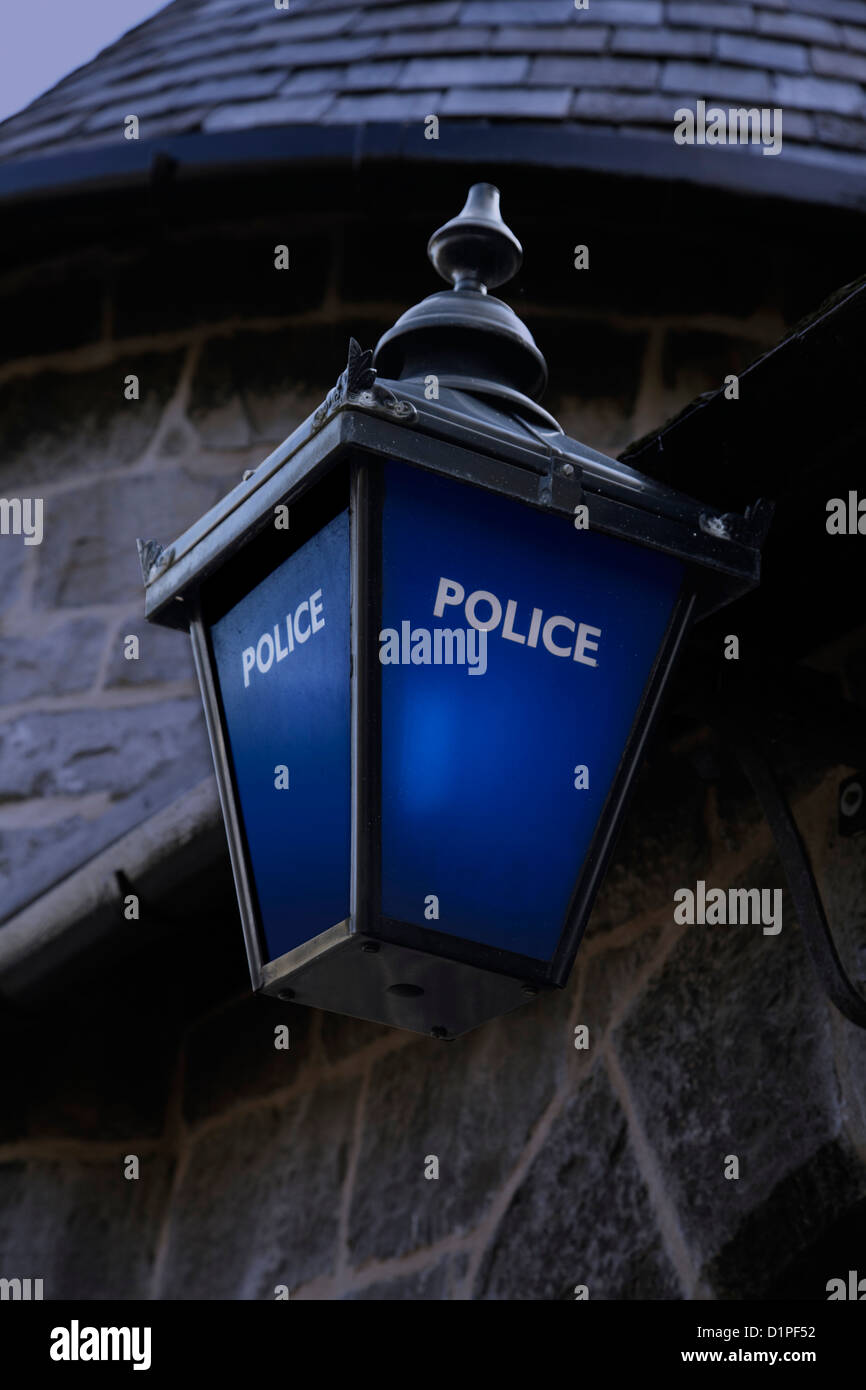 Police blue lamp lit up at night outside the old Castletown police ...