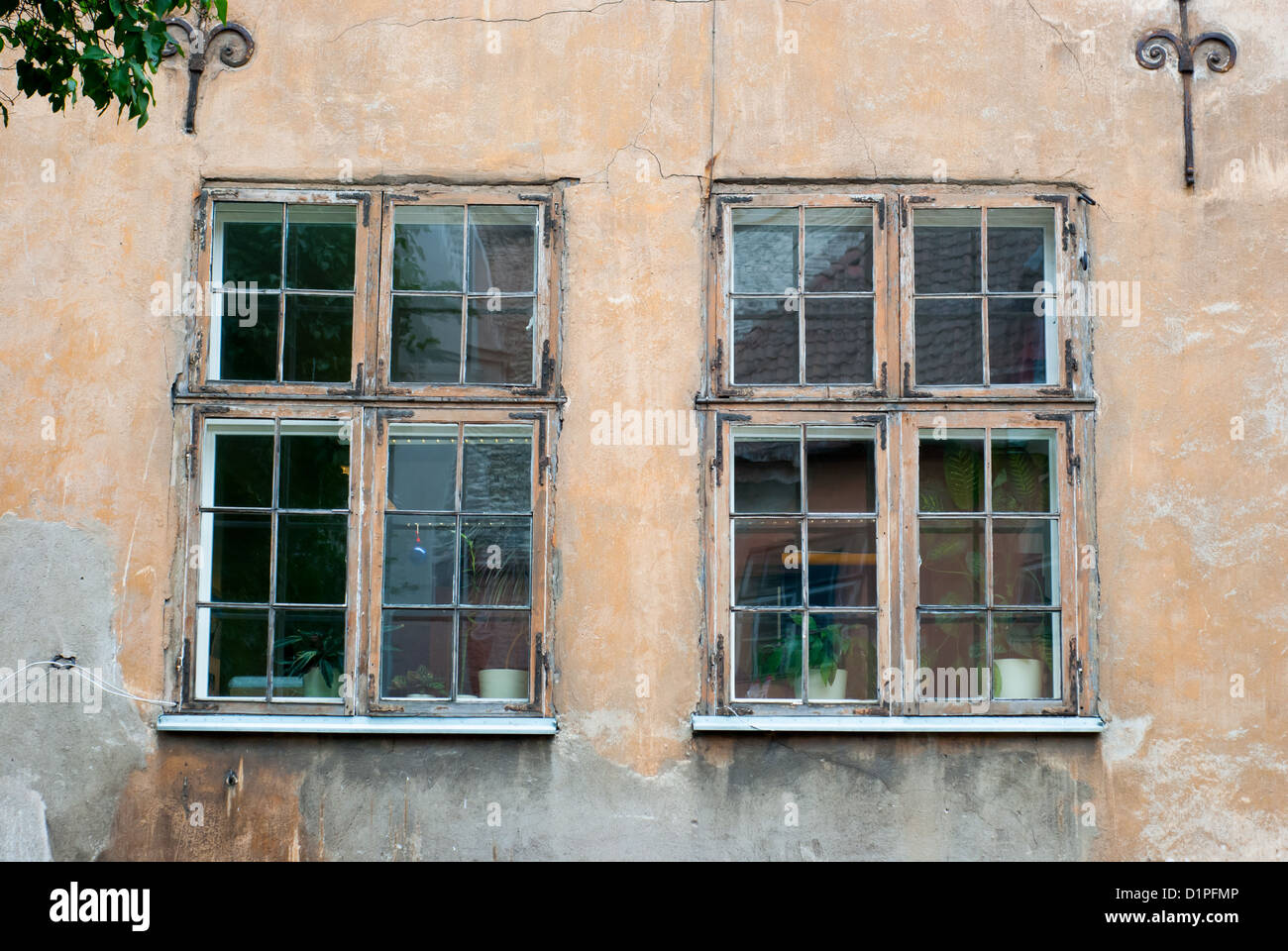 Building exterior with old worn out wooden windows Stock Photo - Alamy