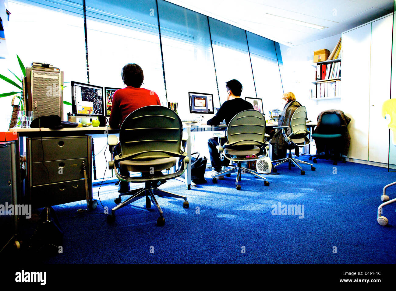 Young Graphic designers working on computers in an office at Central St ...