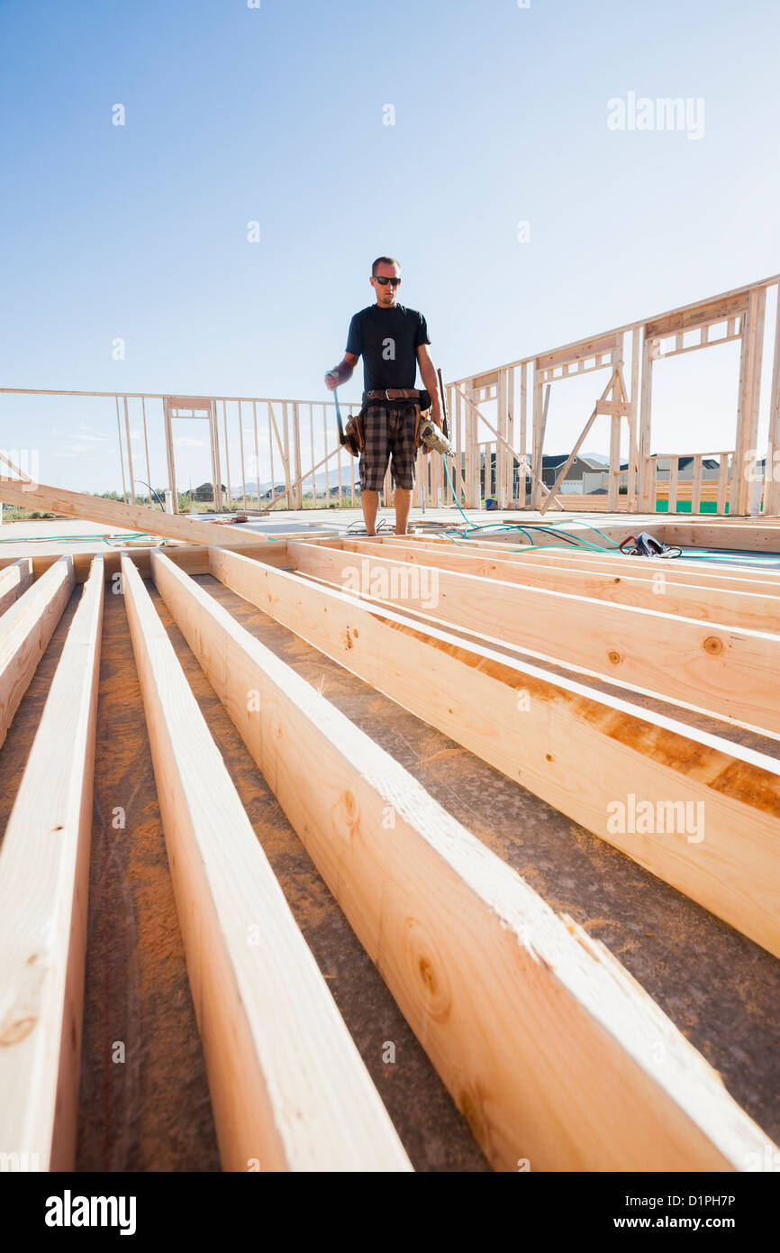 Caucasian man standing with frame on construction site Stock Photo - Alamy