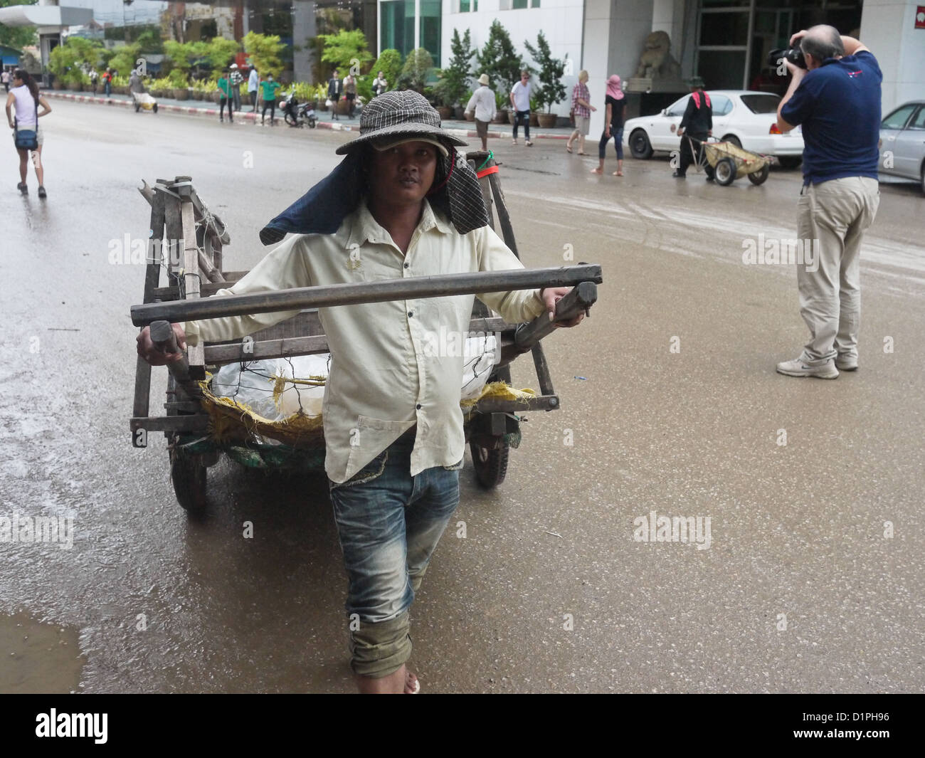 Asian male worker pulling cart Cambodia Stock Photo - Alamy