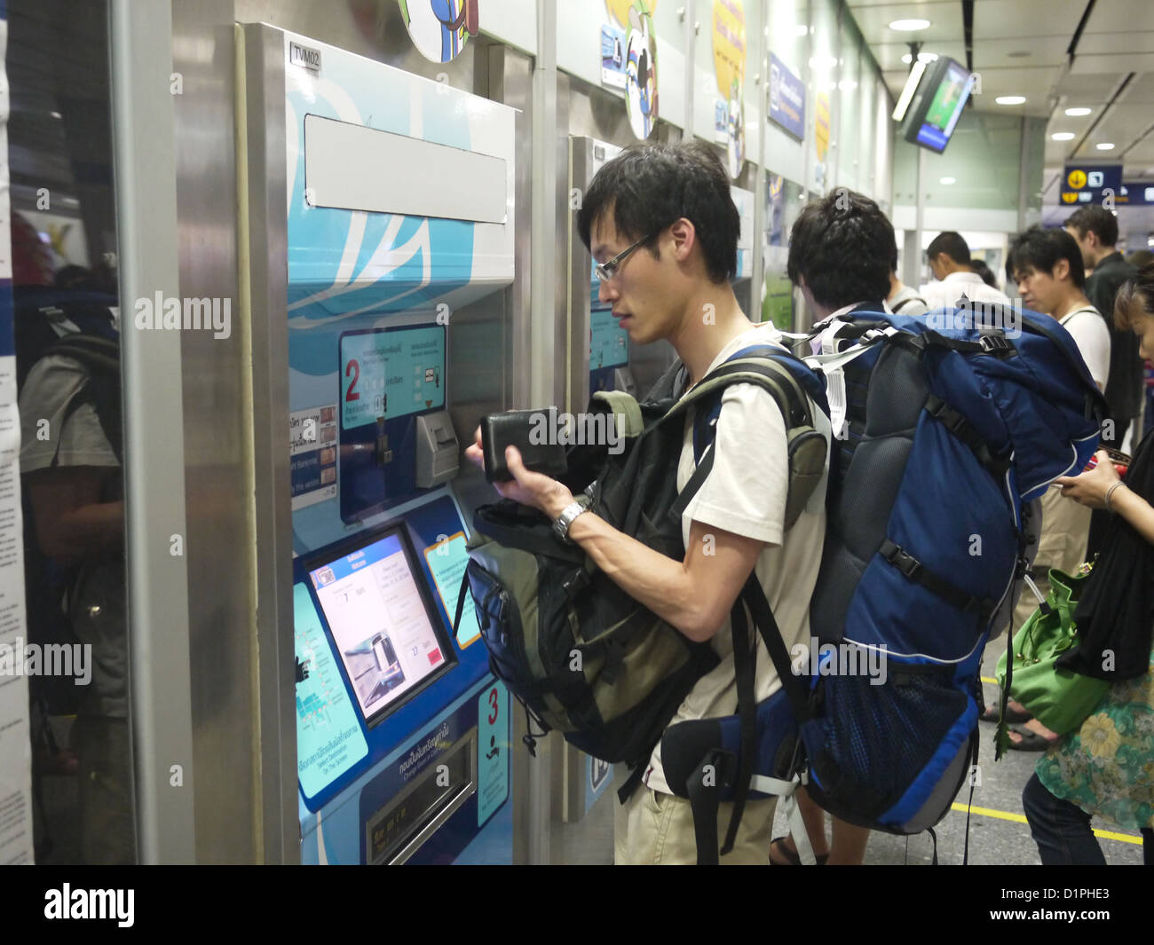 male backpacker buying train fare Bangkok Thailand Stock Photo - Alamy
