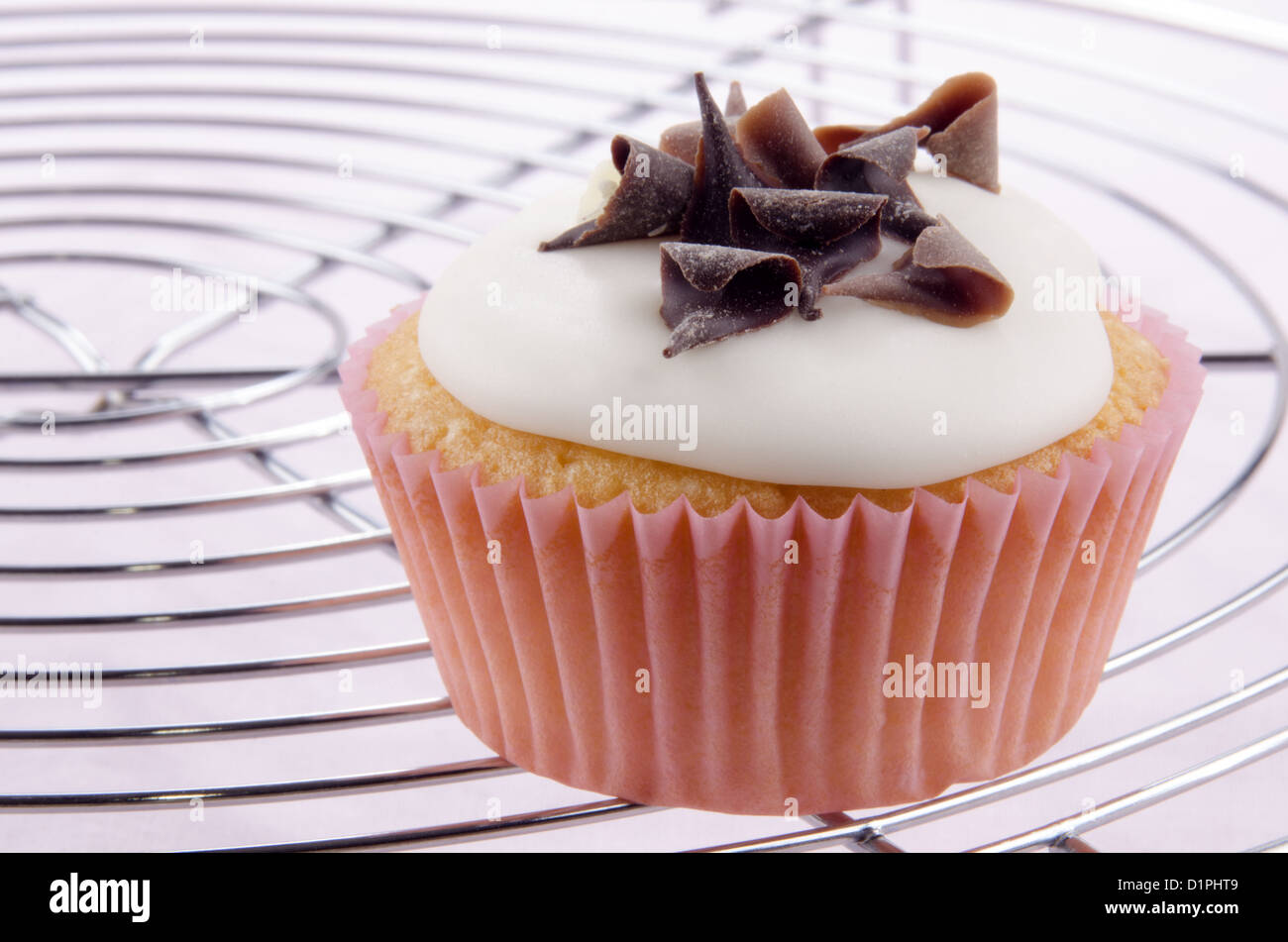 cupcake with white icing and chocolate curls Stock Photo - Alamy