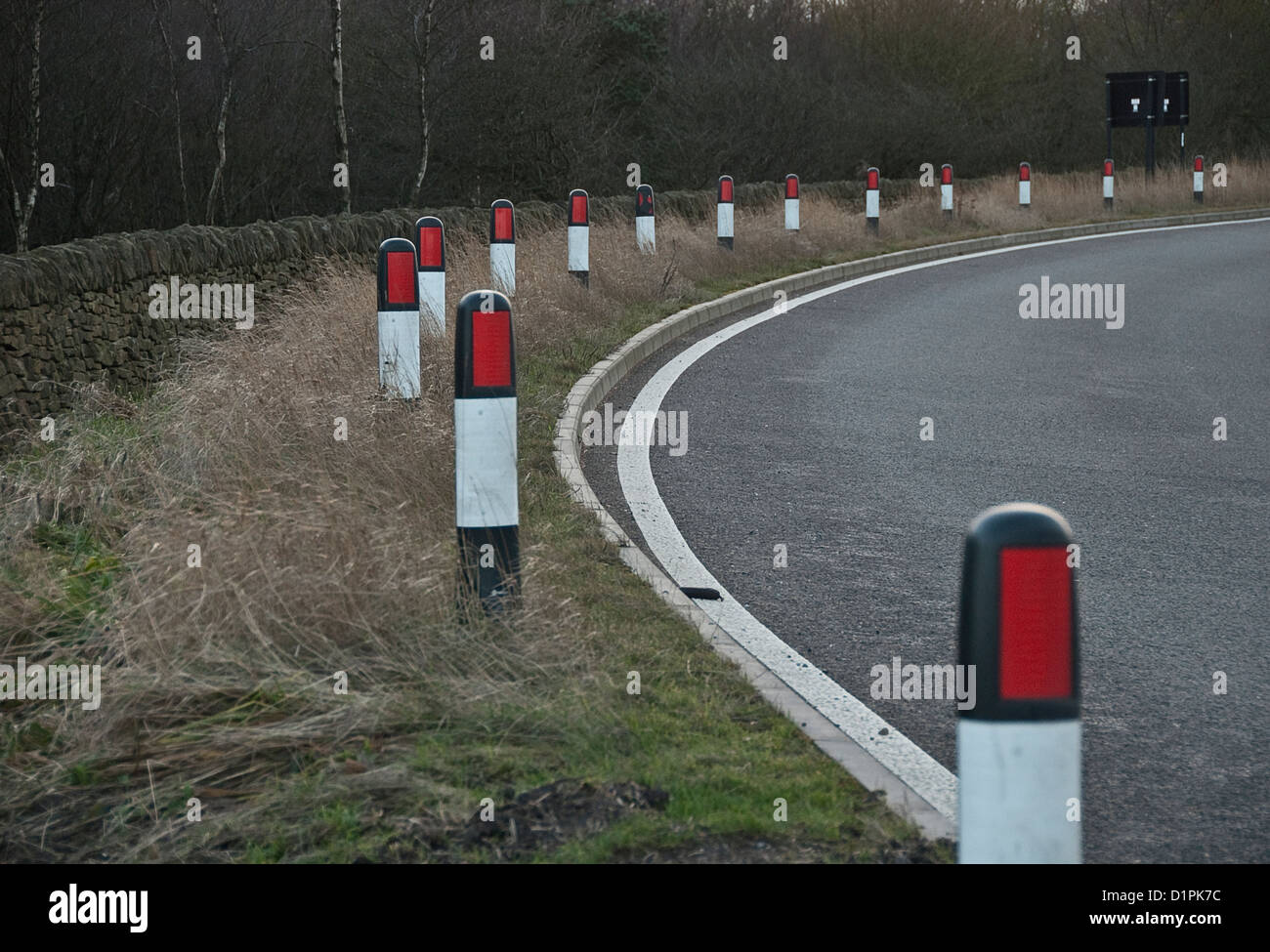 Caution bollards on a dangerous curve ion country road Stock Photo - Alamy