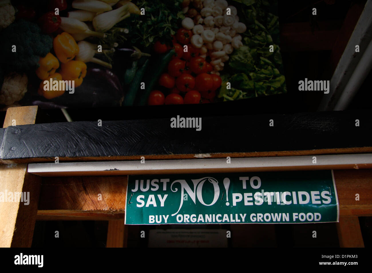 A campaign sign inside a small organic vegetable self-serviced shop in ...