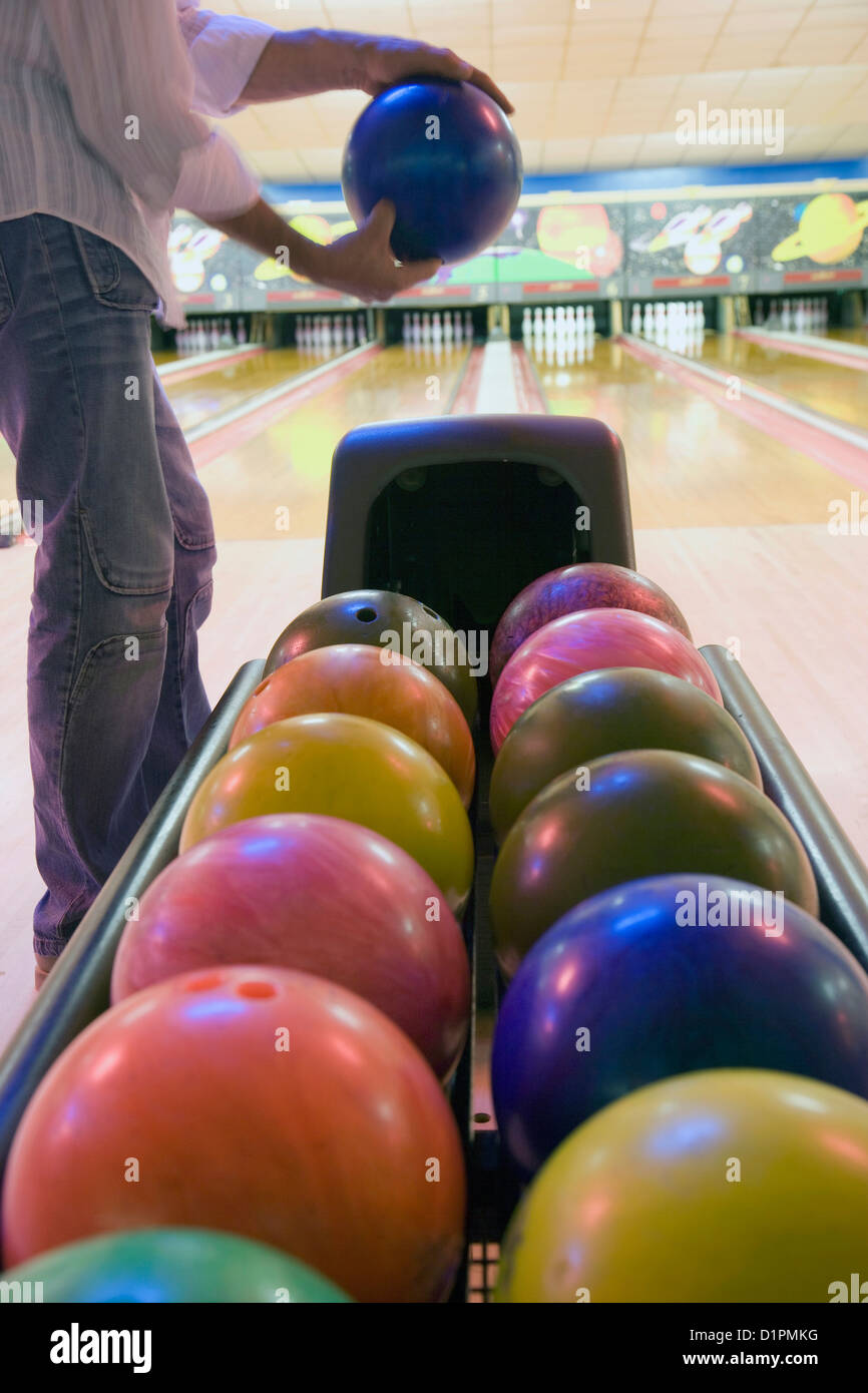 Bowler holding bowling ball Stock Photo - Alamy