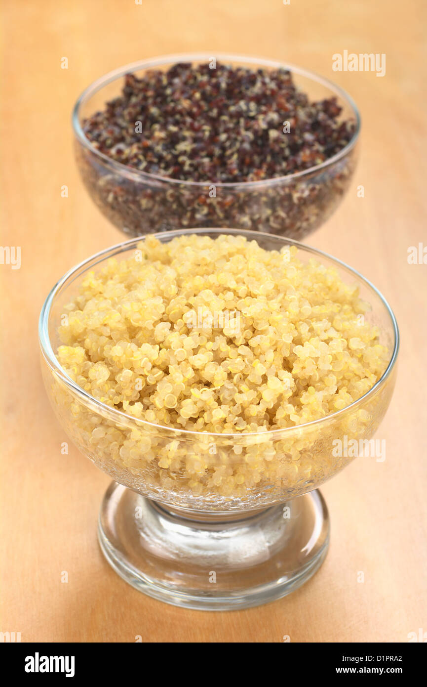 Cooked white and red quinoa in glass bowls which can be eaten as a side ...