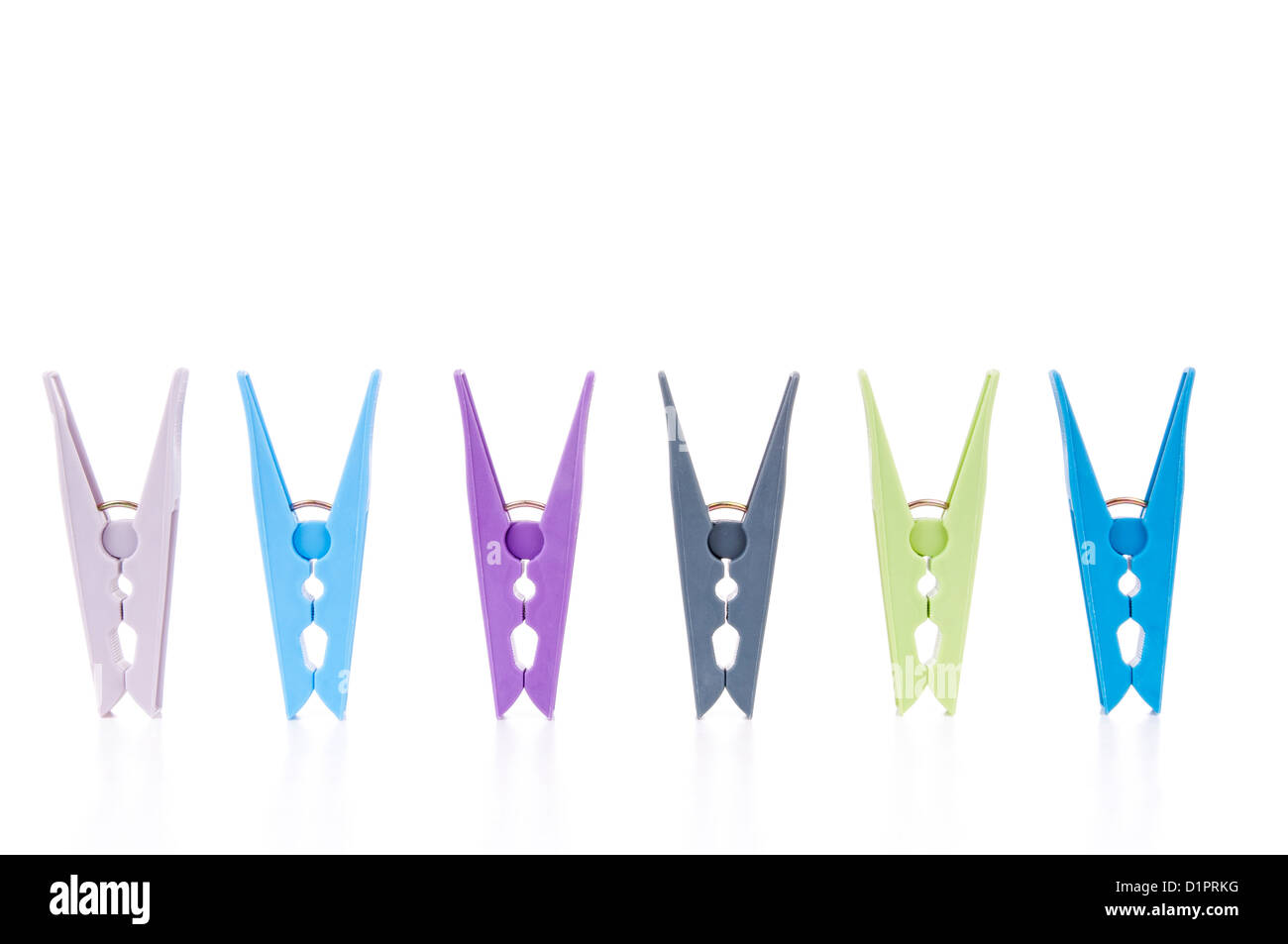 Colorful pegs isolated on white Stock Photo - Alamy