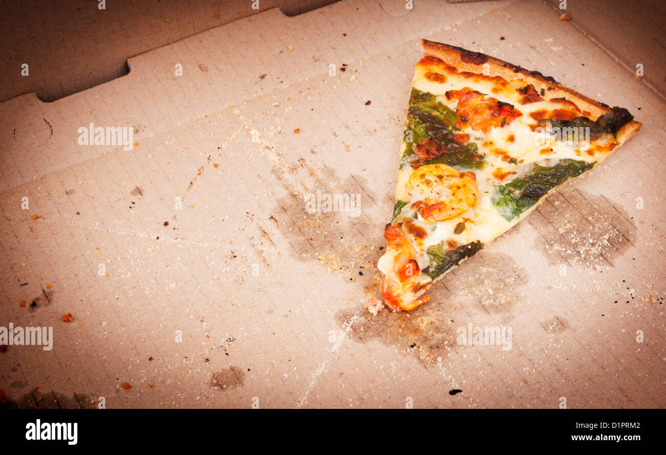 Pizza slice last one left in the pizza box Stock Photo - Alamy