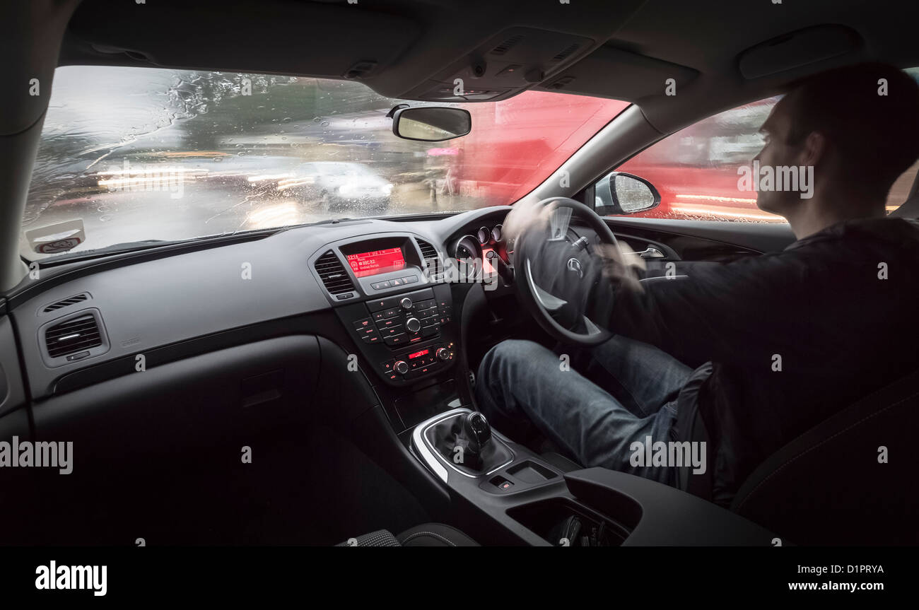 Driving along a busy road in poor weather from inside the car Stock ...