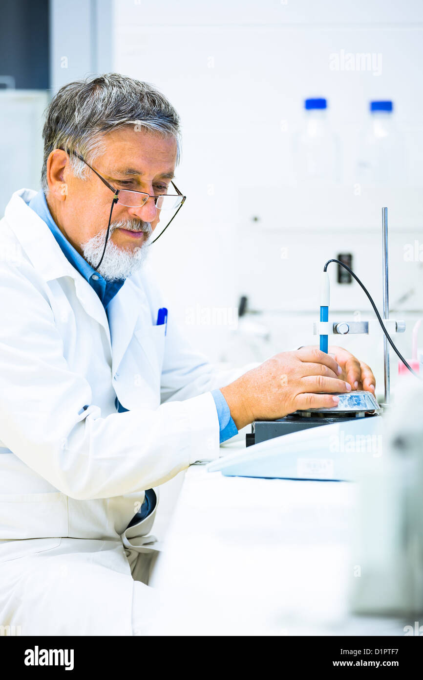 Senior male researcher carrying out scientific research in a lab ...