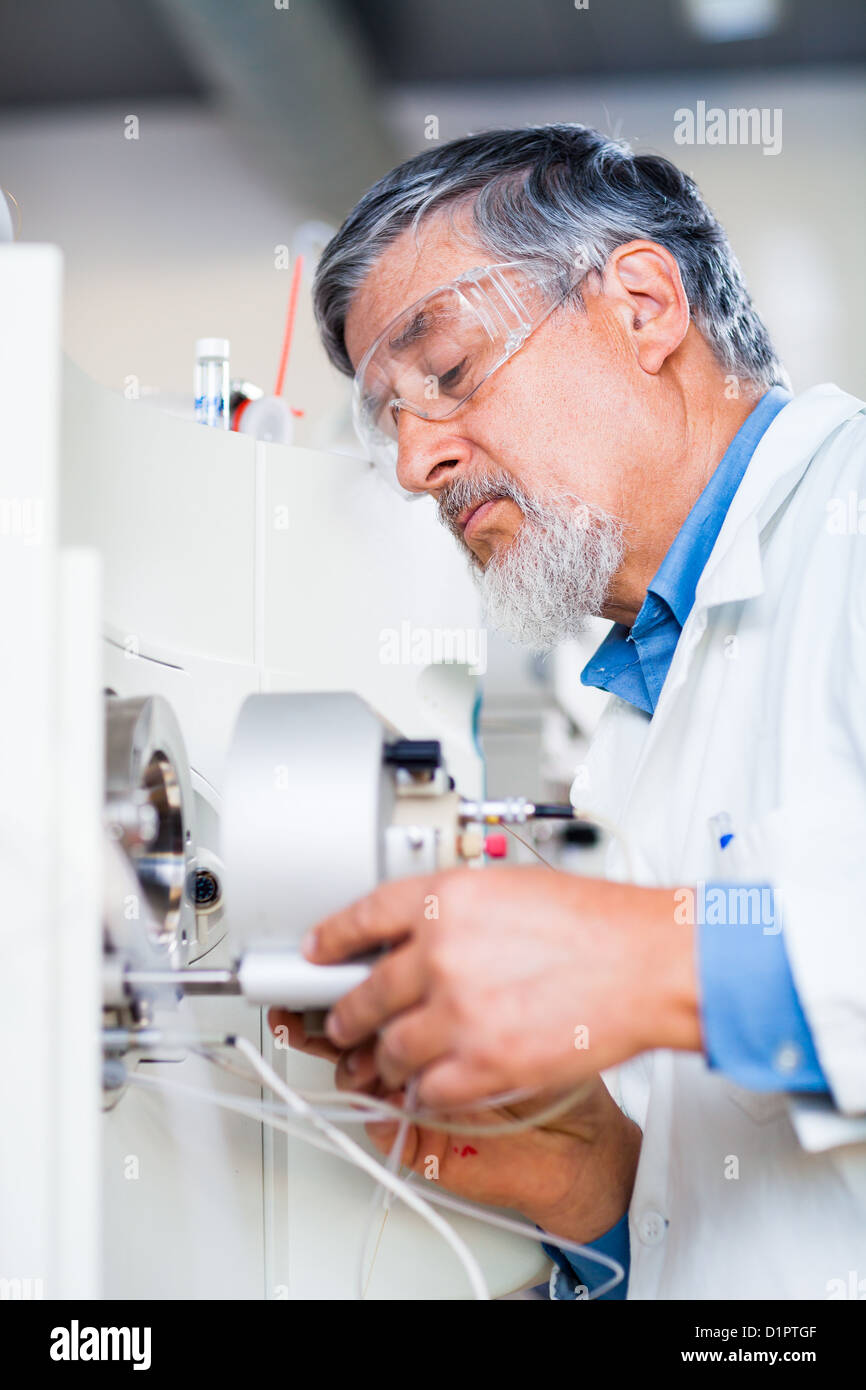 Senior male researcher carrying out scientific research in a lab ...