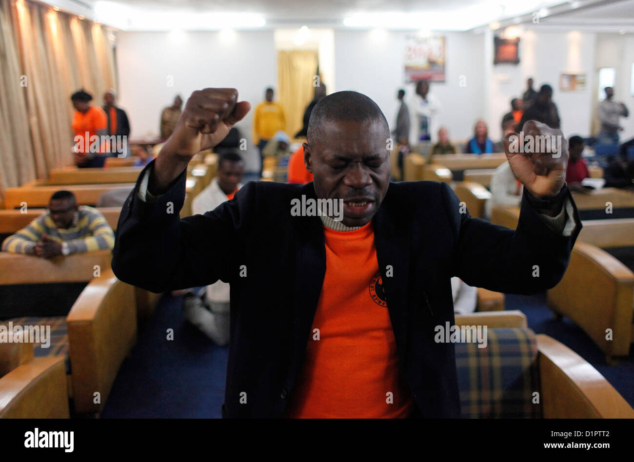 African migrants praying on new year's eve in a church of migrants in ...