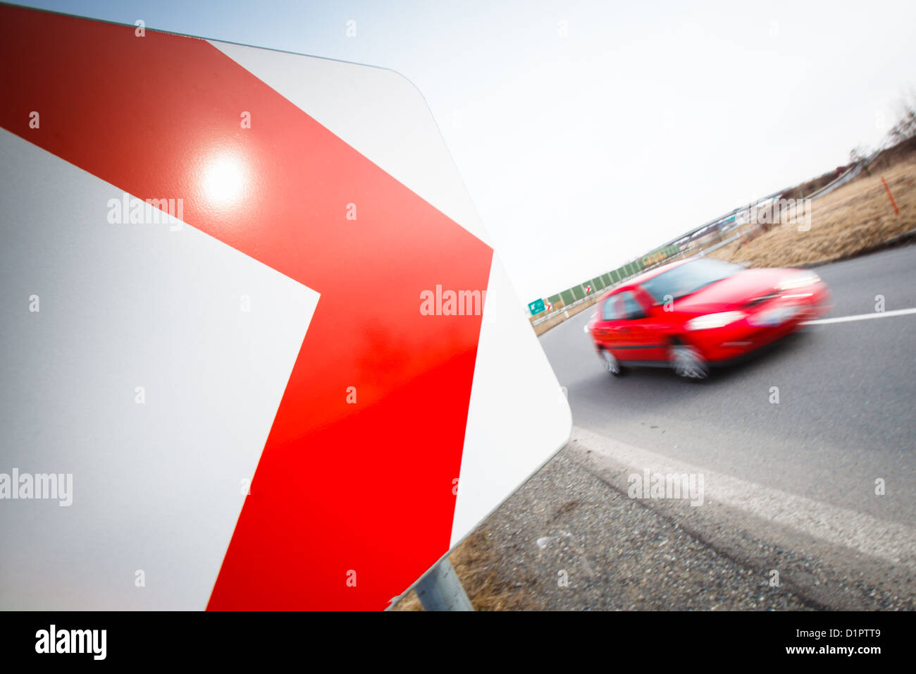 Traffic concept: car driving fast through a sharp turn (motion blur is ...