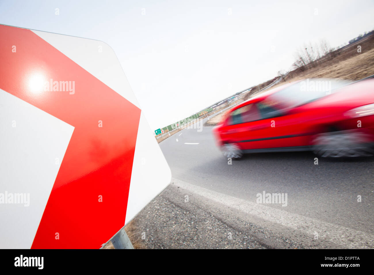 Traffic concept: car driving fast through a sharp turn (motion blur is ...