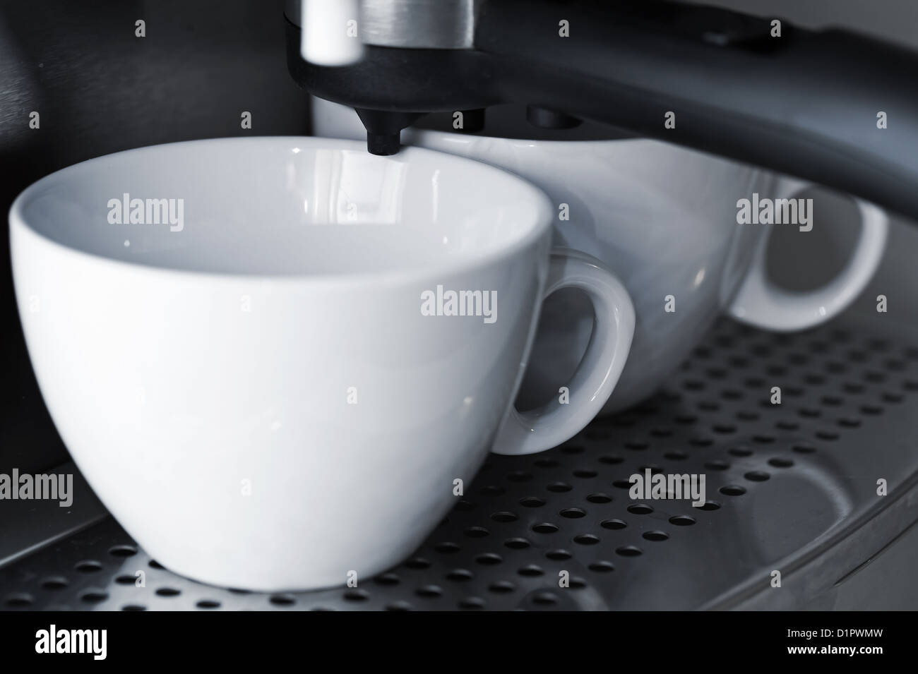 Empty white ceramic cups in espresso coffee machine Stock Photo - Alamy