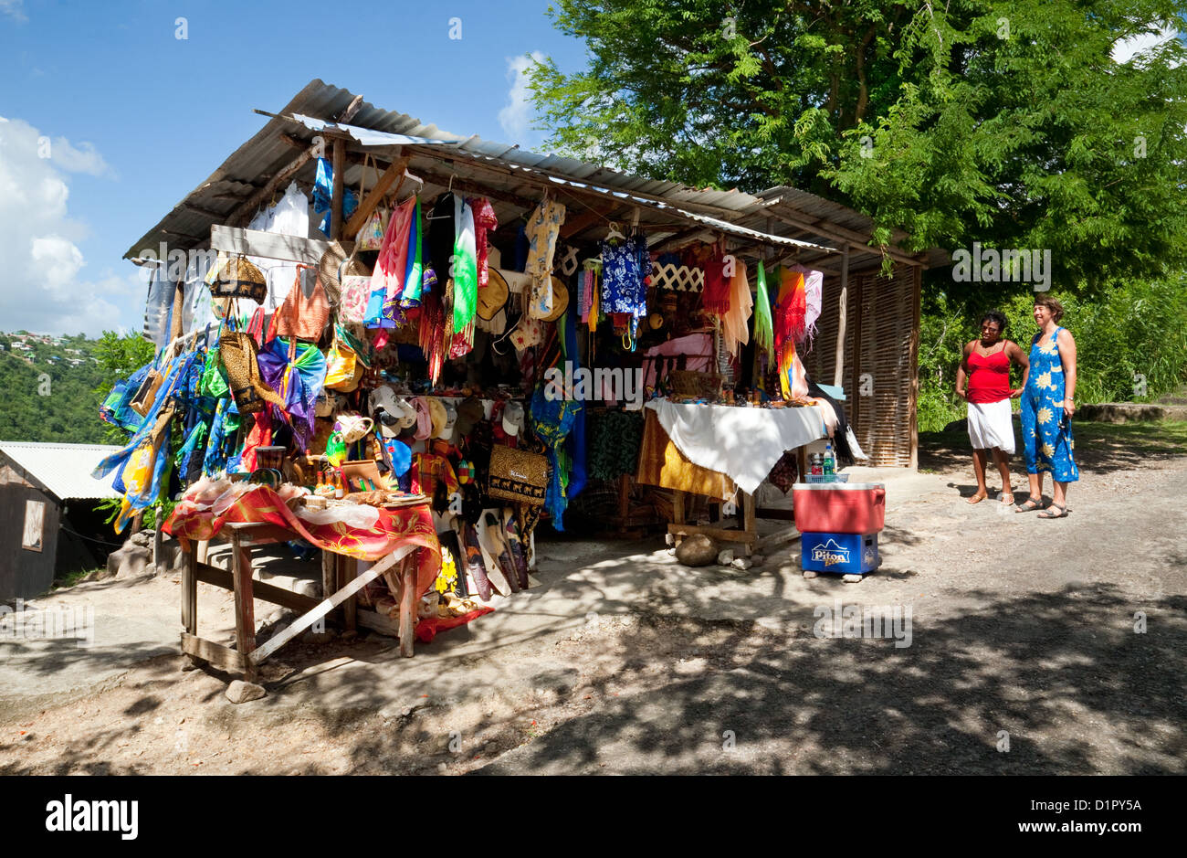 A tourist shopping at a colourful clothes stall, Castries, St Lucia ...