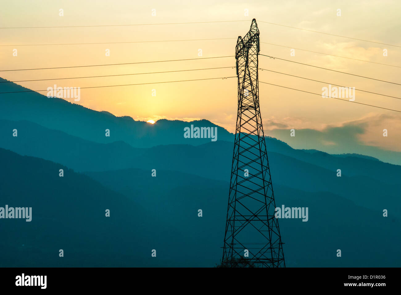 Electric Power lines at Sunset mountain view Stock Photo - Alamy