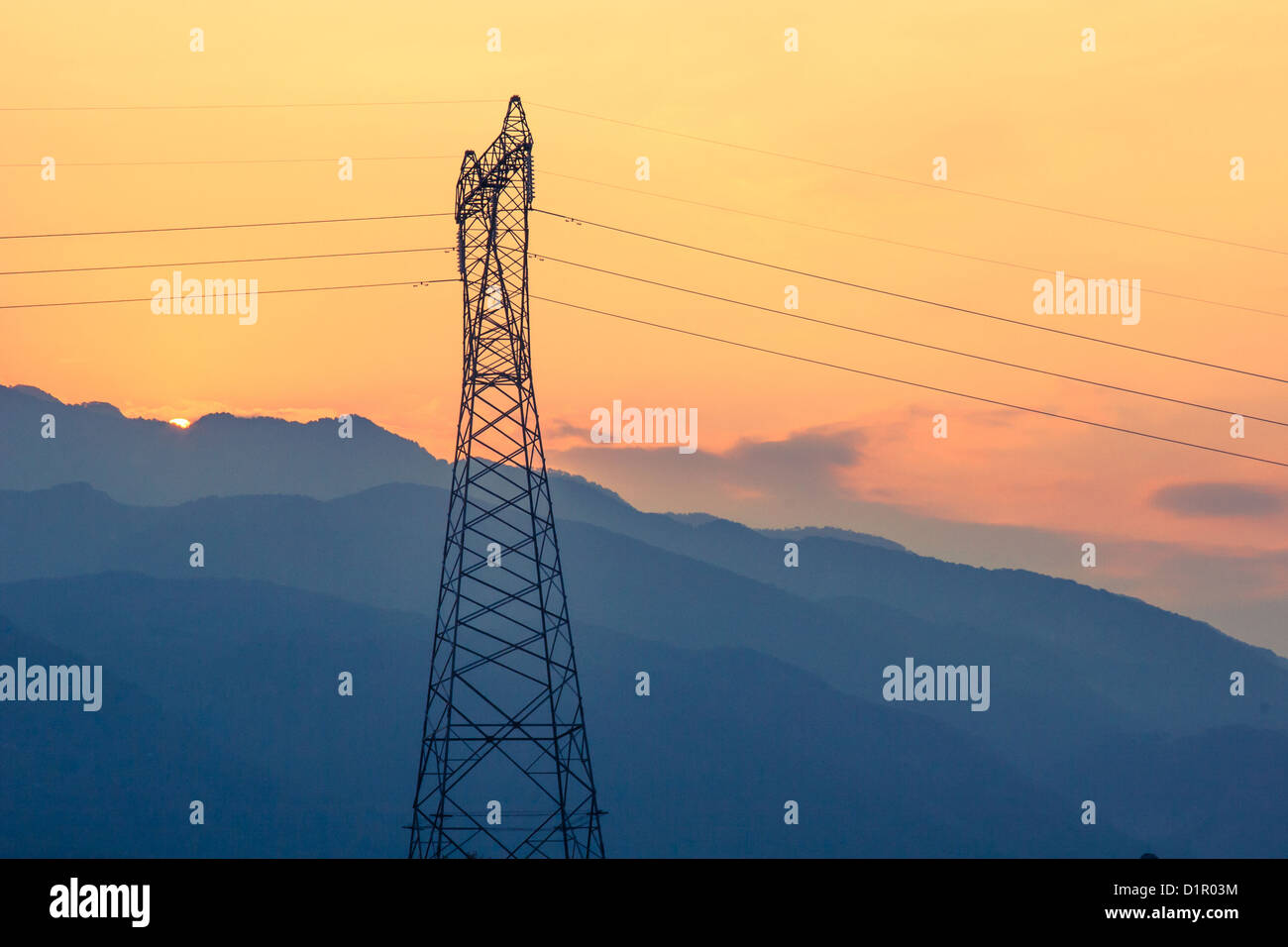 Electric Power lines at Sunset mountain view Stock Photo - Alamy