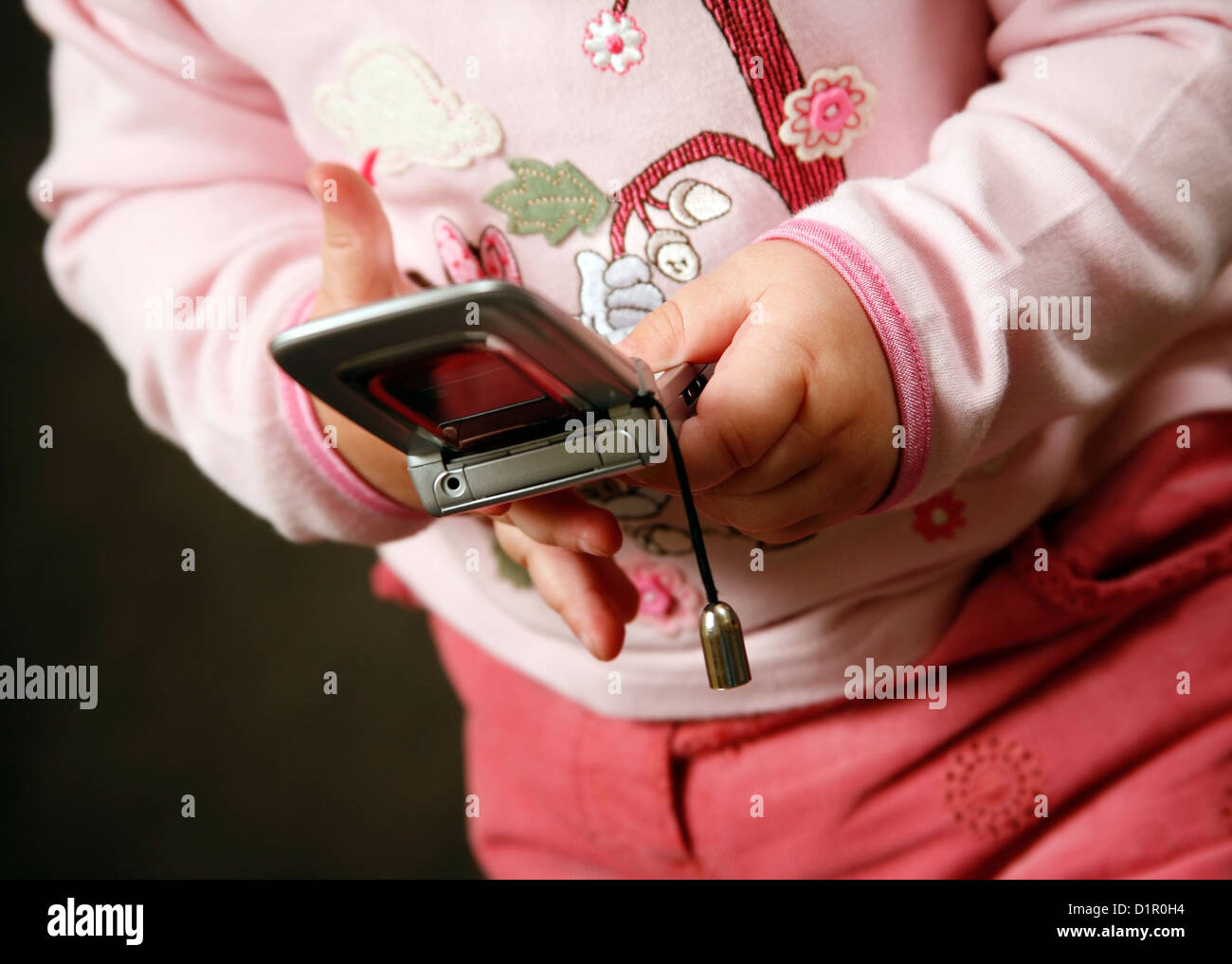 Baby's hands playing with cell phone Stock Photo - Alamy