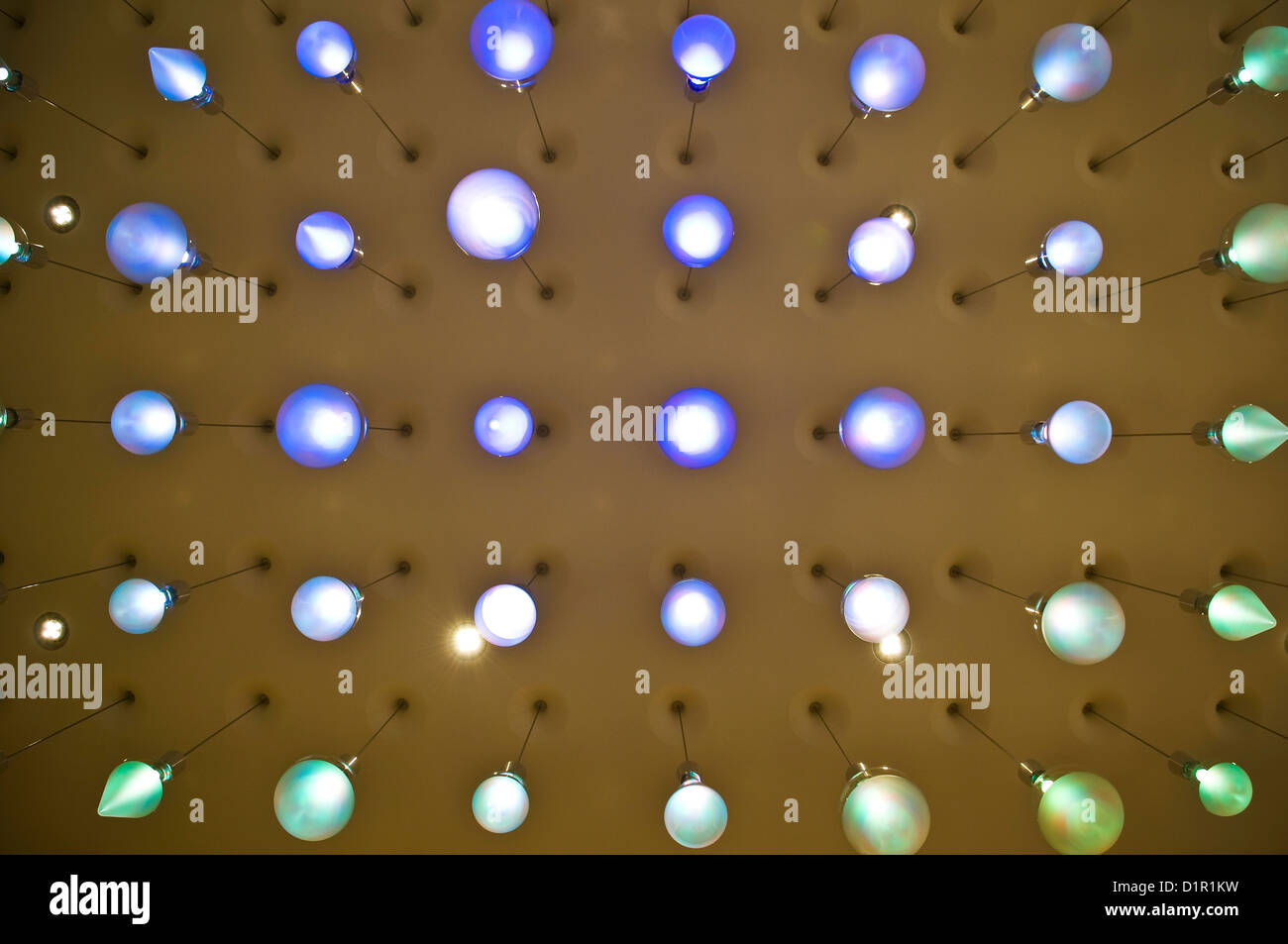 Multiple electric coloured lights hanging from a ceiling Stock Photo ...