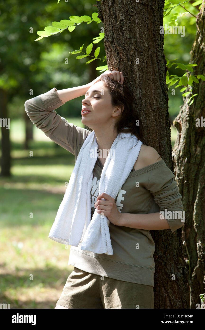 woman resting after exercising in a park Stock Photo - Alamy