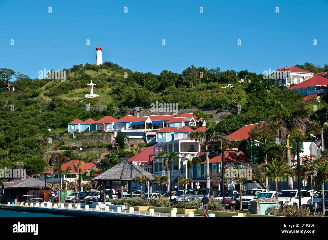 Downtown Gustavia along the waterfront quay with hill and red-roofed ...