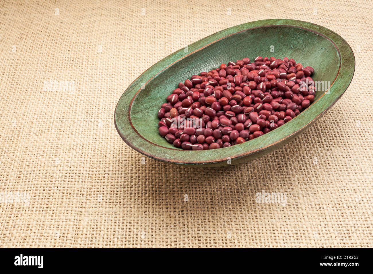 Japanese adzuki (aduki, azuki) beans in a rustic wood bowl against ...
