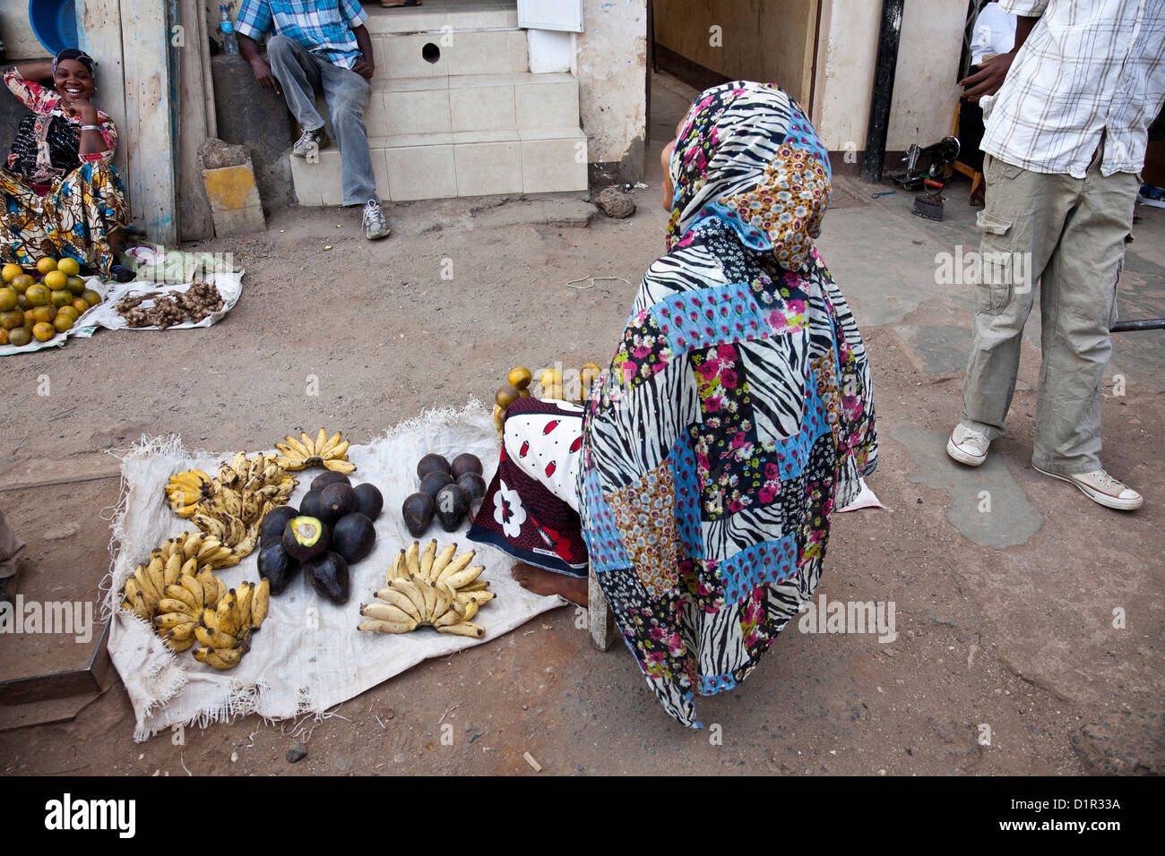 Africa;Tanzania;Moshi; Muslim woman selling outdoor fruit and vegetable ...
